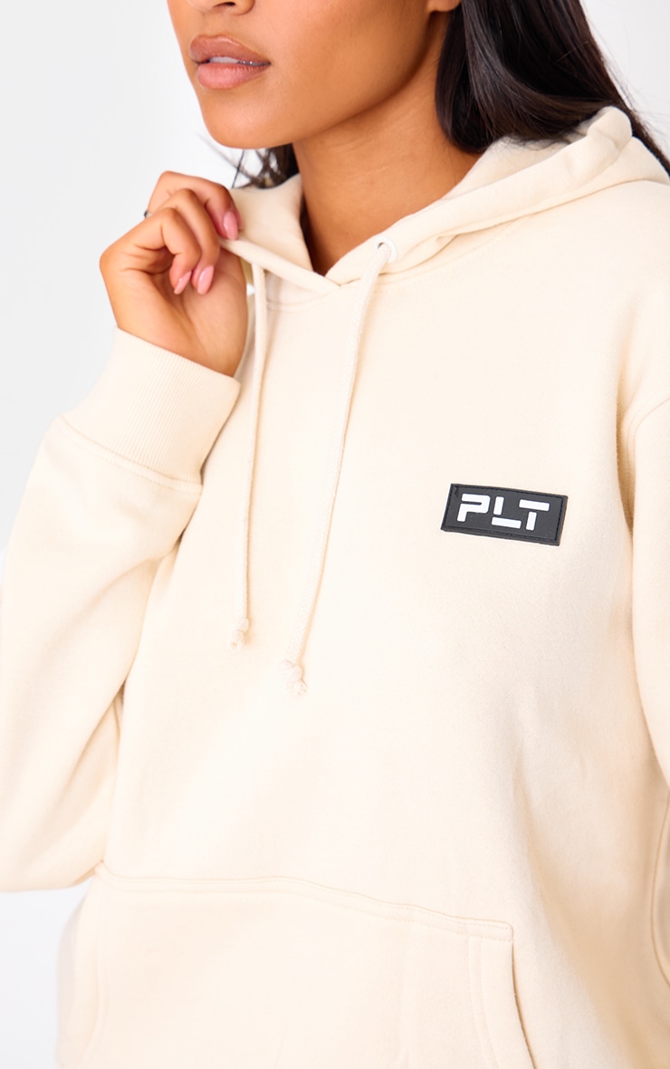 PLT Tall Cream Oversized Badge Detail Hoodie | Tall | PrettyLittleThing USA
