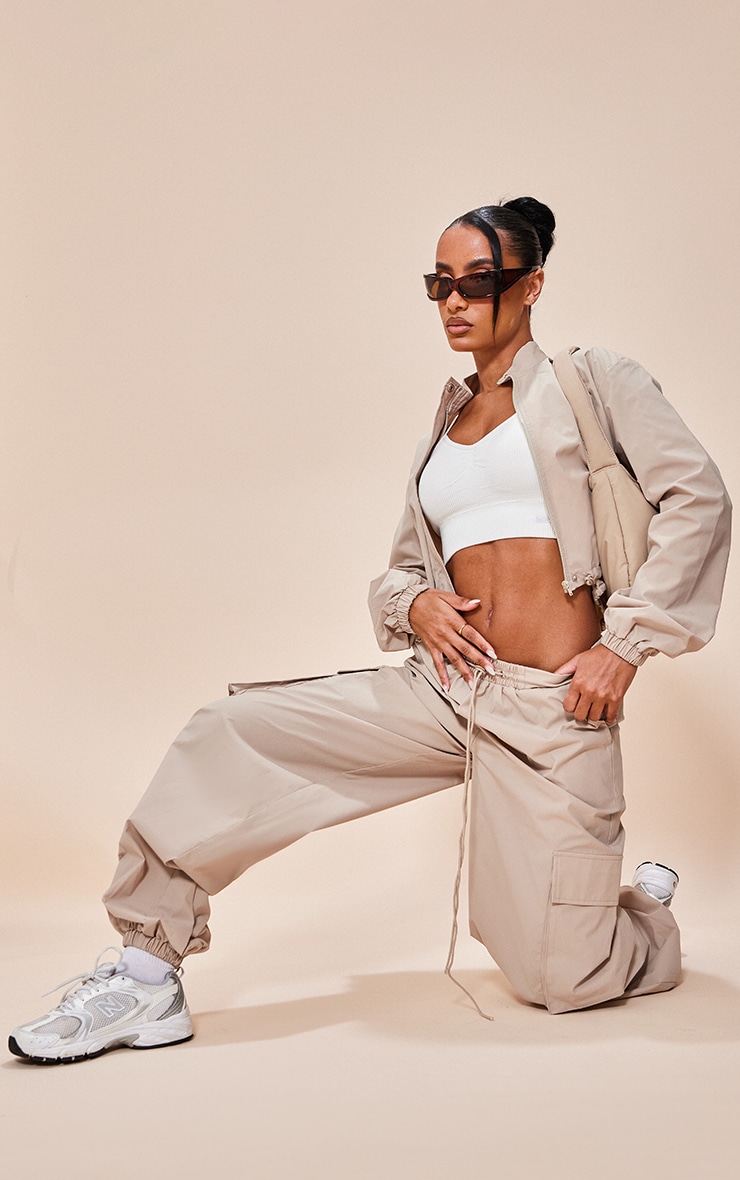 Stone Parachute Zip Up Hem Crop Lightweight Jacket | PrettyLittleThing USA