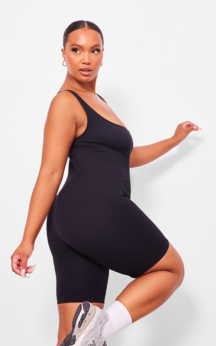 Plus Black Snatched Ribbed Scoop Neck Unitard | PrettyLittleThing USA