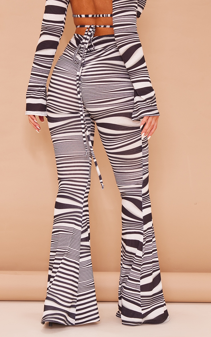 Black Wave Print Tie Waist Detail Flared Pants | PrettyLittleThing USA