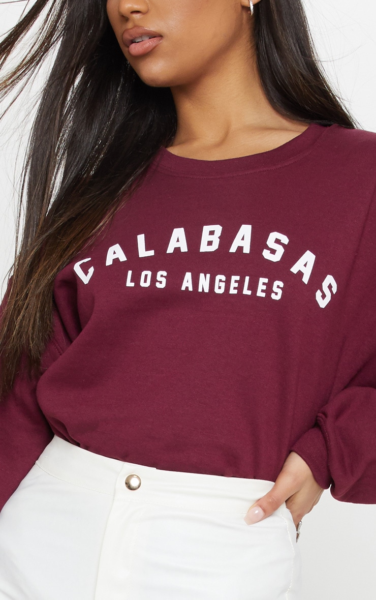Burgundy Calabasas Slogan Print Sweater | PrettyLittleThing
