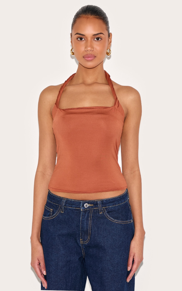 Burnt Orange Halter Neck Twist Strap Crop Top | Tops | PrettyLittleThing